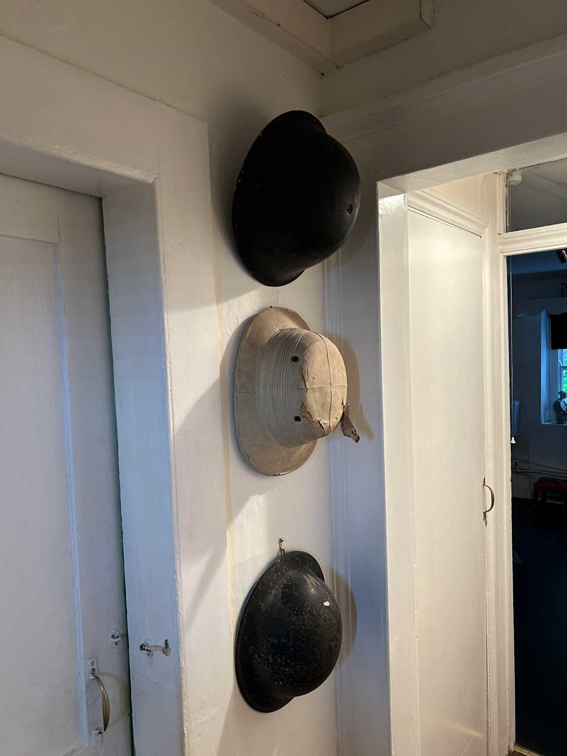 Lot 64 - A SET OF THREE MILITARY HELMETS, Largest