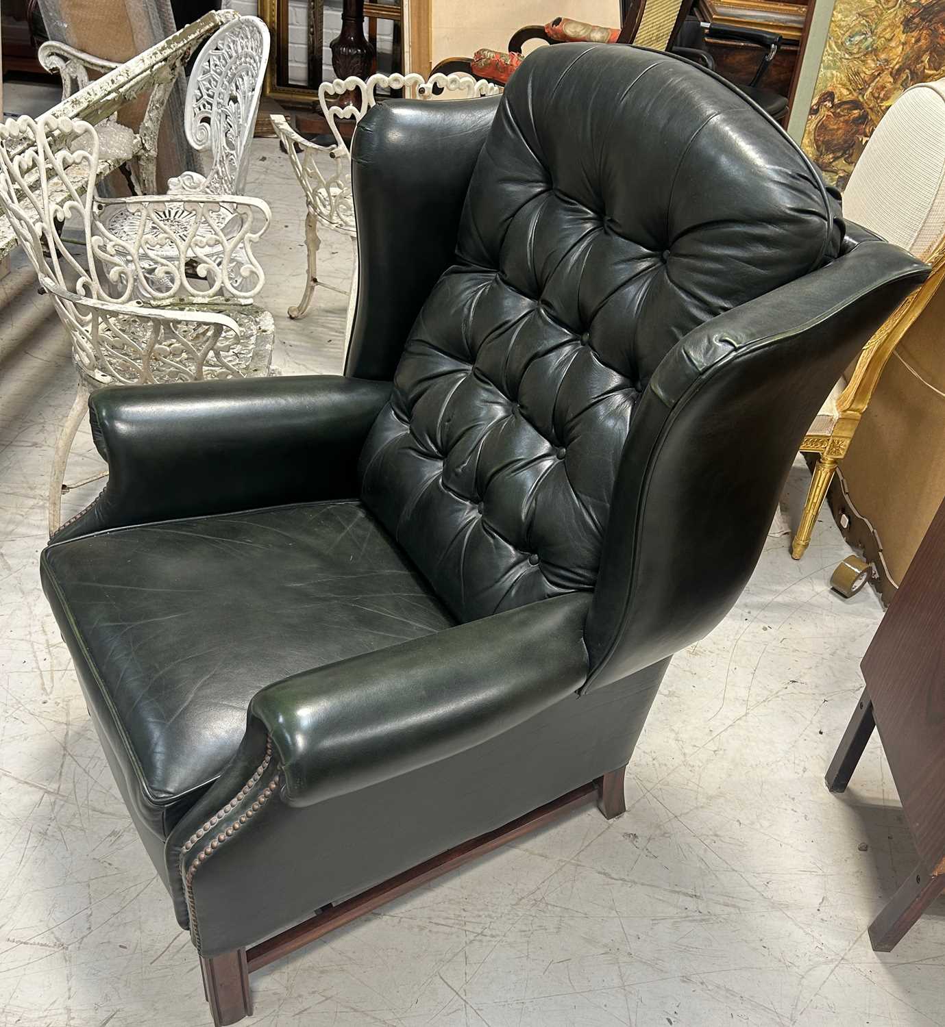 Lot 765 - A GREEN LEATHER BUTTON BACK RECLINING