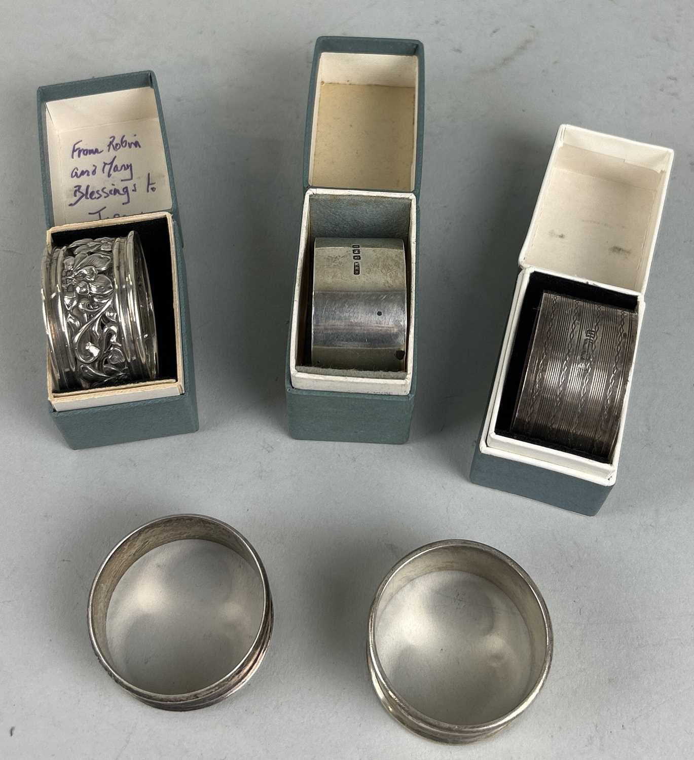 Lot 295 - FIVE SILVER NAPKIN RINGS THREE WITH BOXES